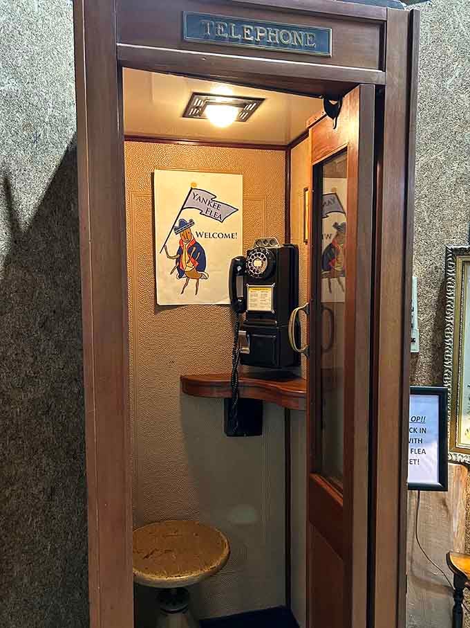 A vintage telephone booth stands ready, complete with rotary phone, for when you need to call 1955.