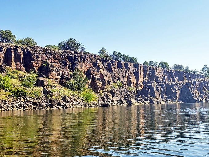 These ancient volcanic cliffs have been perfecting their reflection game for millennia. Talk about commitment to appearance that puts Instagram filters to shame.