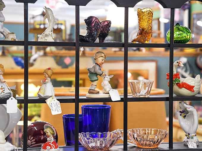 Tiny porcelain people and colored glass living their best shelf life. That cobalt blue glassware is practically screaming to come home with you.