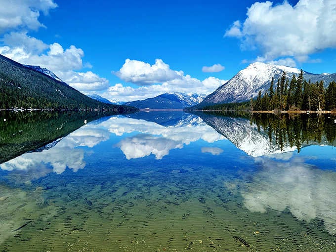 Water so clear you can count fish like sheep, mountains so majestic they belong on Swiss currency, and reflections so perfect they'll make Narcissus jealous.