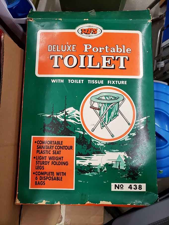 The "Deluxe Portable Toilet" box proves one shopper's trash is another's camping essential. Adventure awaits, complete with "sanitary contour plastic seat!"