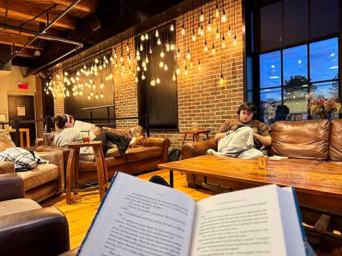 Leather sofas and hanging lights create the kind of reading nook that makes you want to cancel all your plans.