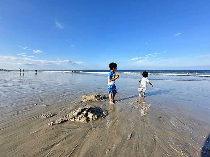 Childhood wonder unfolds at the water's edge, where sandcastle architects discover that the Atlantic makes for both a creative collaborator and a playful destroyer.