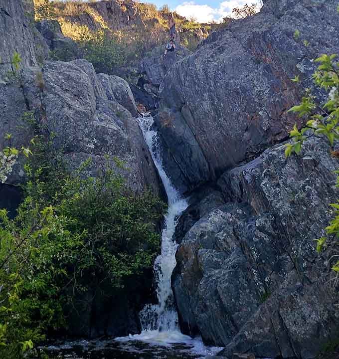 Hidden waterfalls like this one are Lory's best-kept secrets, tucked between rocky walls like nature's own speakeasy.
