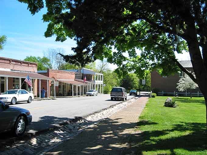 Spring blossoms frame a main street where brick storefronts and manicured lawns prove small towns do sophistication beautifully.