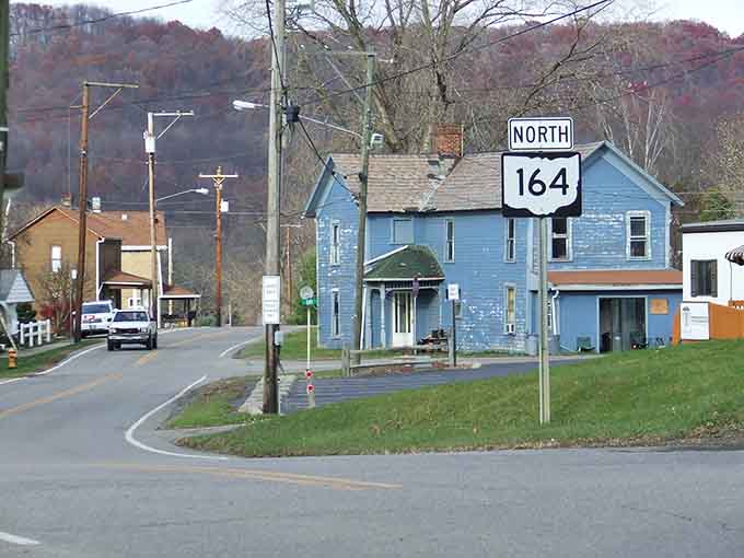 Route 164 winds through Bergholz like a ribbon, connecting modest homes where your dollar stretches further than your morning coffee.
