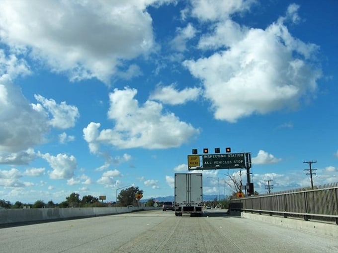 That inspection station sign means you're entering California proper, where even the desert towns offer surprising affordability and charm.