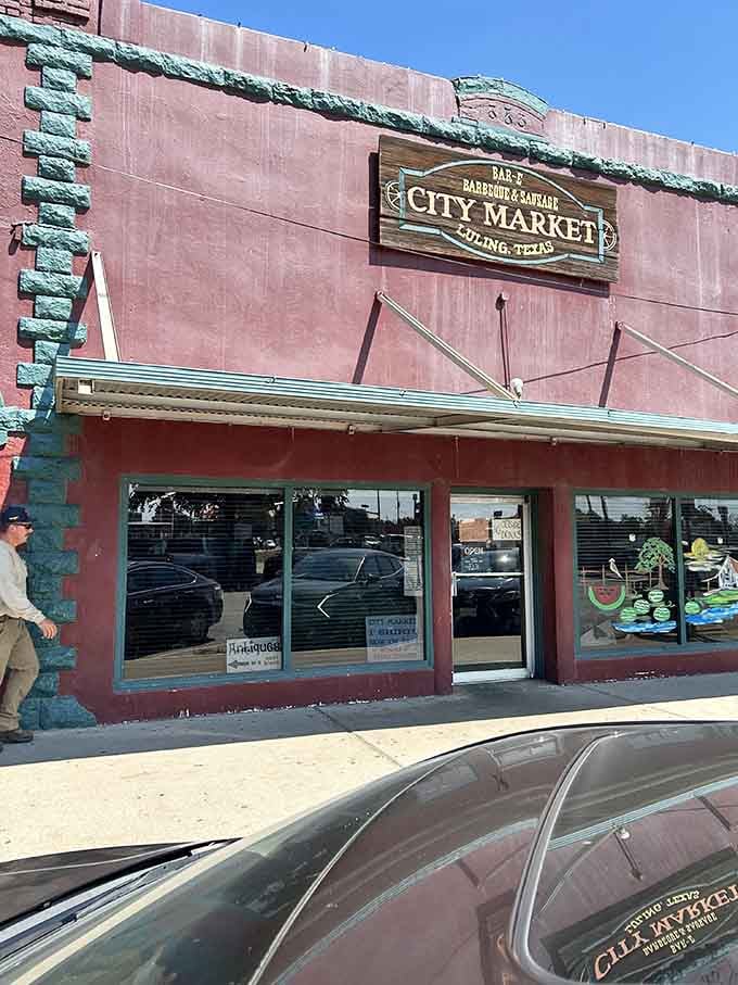 City Market's historic pink building stands as a colorful landmark in Luling's barbecue landscape.