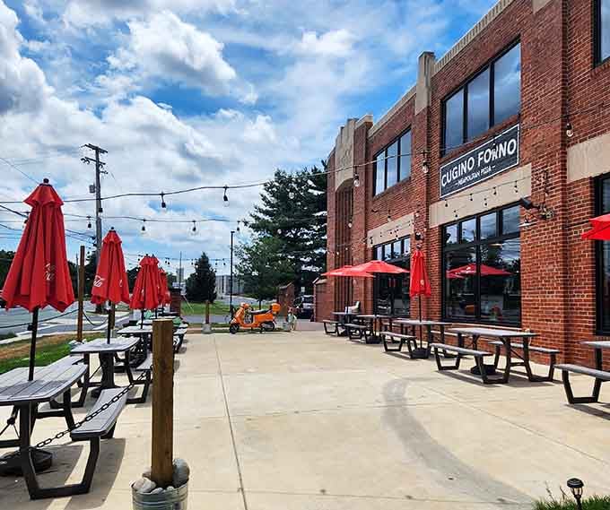 Cugino Forno's spacious patio with bright red umbrellas creates the perfect pizza party atmosphere. Al fresco dining at its finest!