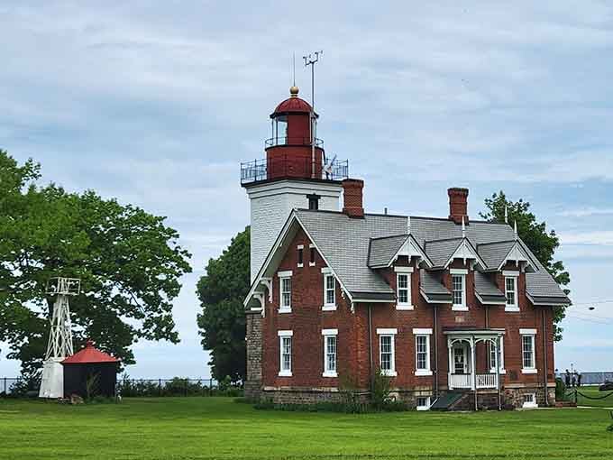 The lighthouse stands sentinel over the water, offering million-dollar views without requiring a million-dollar mortgage to enjoy them.