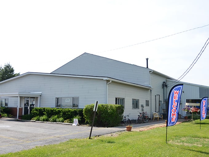 The simple white building sits peacefully along the roadside, promising small-town charm and big-time bargains for savvy shoppers.