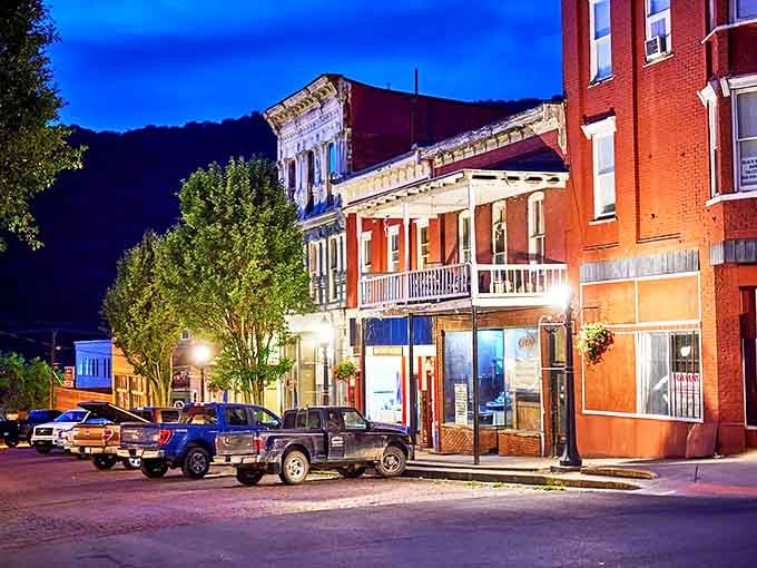 Hinton's historic downtown glows warmly in the evening light, where colorful storefronts create a welcoming atmosphere for budget-conscious residents.