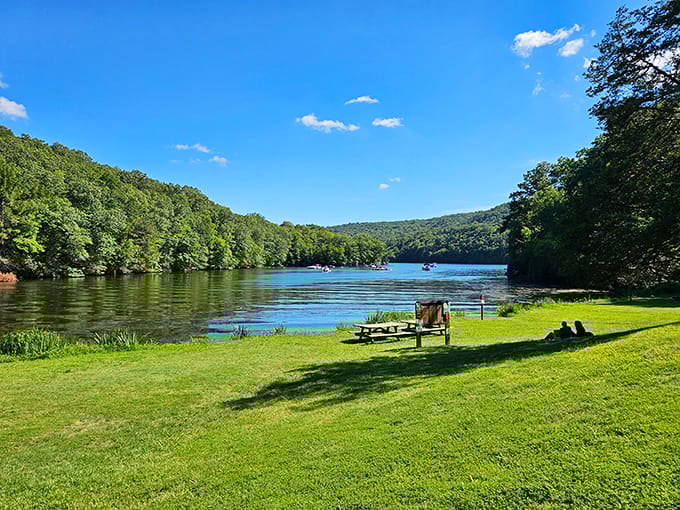 Lake Zoar stretches between green hills like a blue ribbon, with picnic tables positioned for maximum appreciation and relaxation.