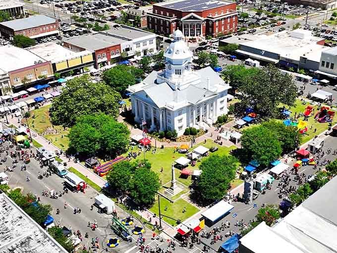 The white courthouse dome rises above festival tents like a wedding cake topper watching over the town's biggest party.