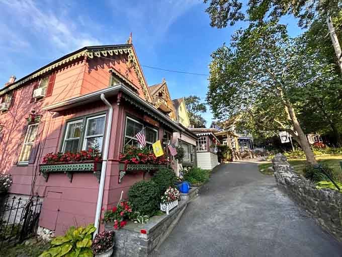 Pink Victorian perfection with flower boxes overflowing—it's like Grandma's favorite teacup became a house and moved to town.