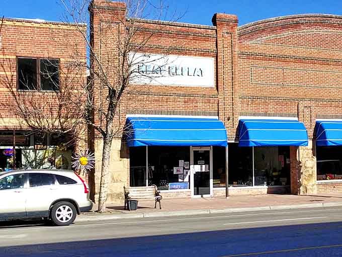 The historic brick fa&ccedil;ade of Neat Repeat in Lander welcomes thrift hunters with its cheerful blue awnings and small-town charm.
