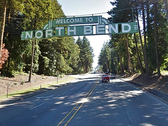 That vintage "Welcome to North Bend" sign arching over the highway is pure Americana at its finest.