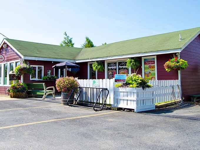 Bright summer blooms and white picket fencing create a cottage-like atmosphere where serious sub sandwiches meet small-town hospitality perfectly.
