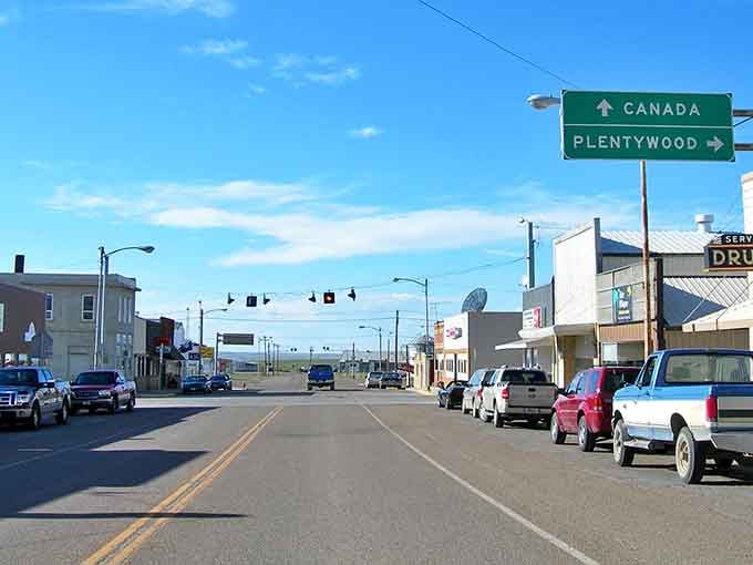 Downtown Scobey welcomes travelers with a sign pointing to Canada, as if saying "Stay here, or keep going&mdash;we won't be offended either way!"