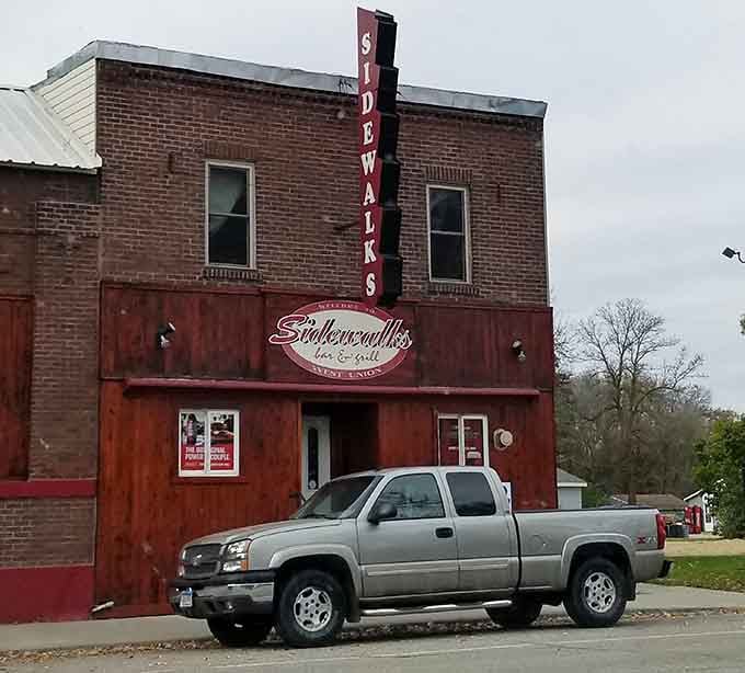The vintage "Sidewalks" sign towers above this brick building like a beacon for burger lovers passing through town.