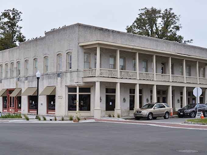 That two-story colonnade stretches elegantly along the street, offering shade and Southern sophistication in equal measure.
