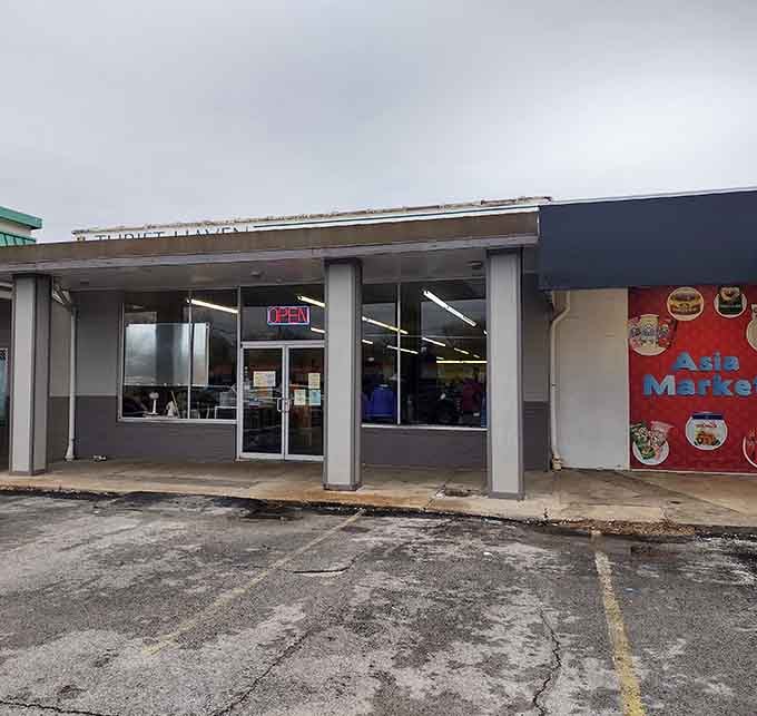 The neon "OPEN" sign glows like a beacon for savvy shoppers seeking deals in this unassuming storefront.