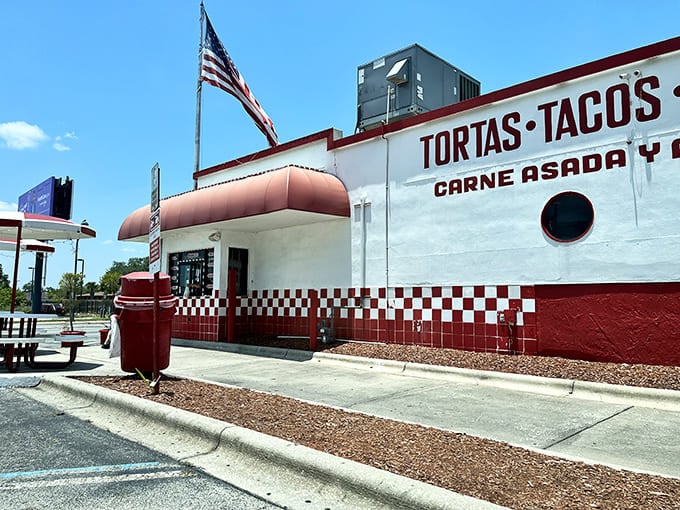 Tortas El Rey's red and white building stands proudly with its American flag, a delicious cultural crossroads.