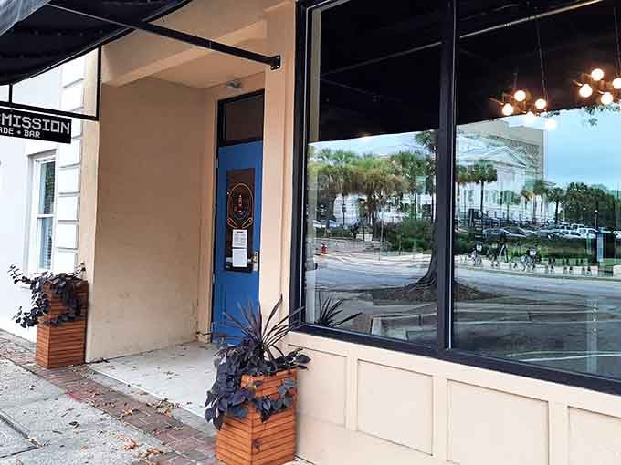 Clean modern lines and welcoming planters frame glass doors that open into a world of vintage gaming nostalgia.