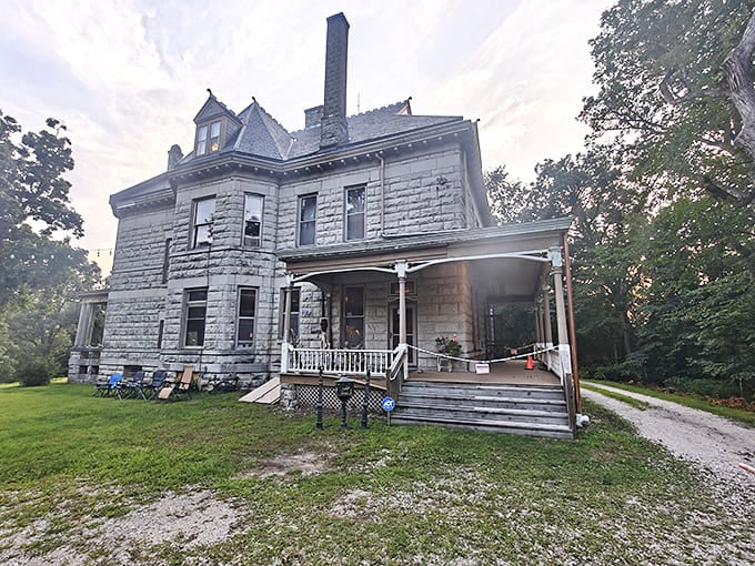 Warner Castle's weathered stone exterior and wrap-around porch blend Victorian architecture with castle-inspired elements.