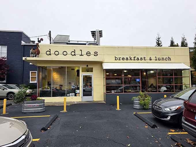 The cheerful yellow awning and playful rooster sculpture signal that breakfast here comes with a generous side of whimsy.