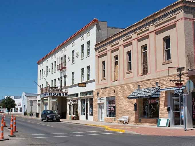 Brick facades stretch down the street, their weathered texture revealing character that modern buildings spend decades trying to fake.