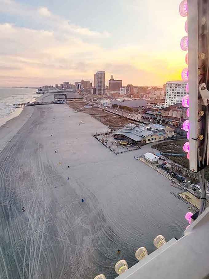 Pink lights frame the boardwalk view at dawn, where ocean meets architecture in a scene straight from a postcard.