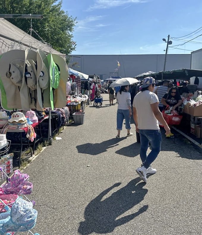 Sunny skies illuminate rows of vendors where yesterday's forgotten items become tomorrow's cherished finds under cheerful white tents.