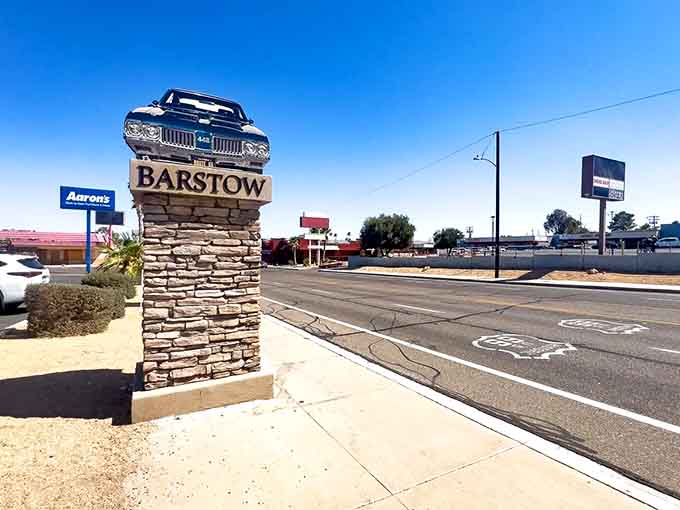 A vintage car monument marks Barstow's entrance, celebrating the desert town's role as a crossroads of American travel.