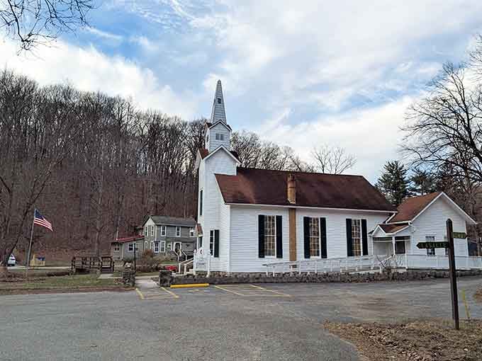 The white church steeple points skyward against bare trees, looking like a Norman Rockwell painting come to life.