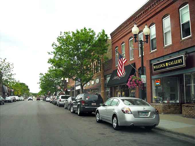 American flags wave above brick buildings where neighbors still know each other's names and favorite coffee orders.