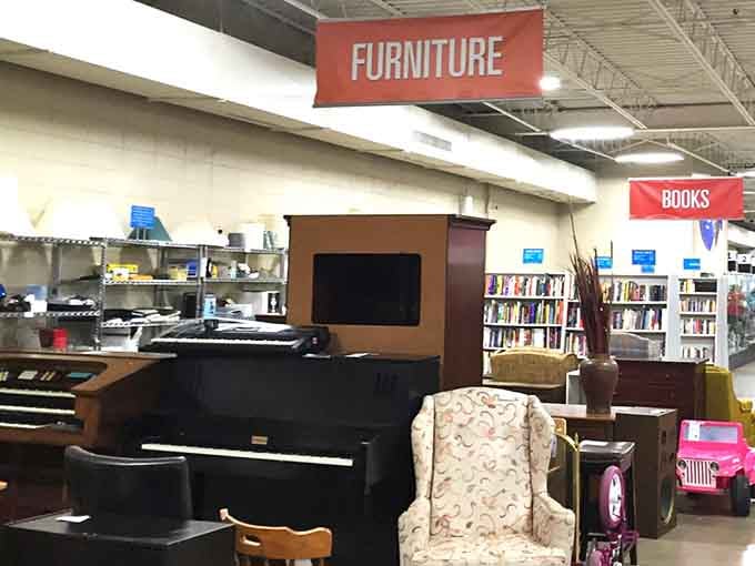 A grand piano sits majestically among furniture and books, proving that culture and affordability can absolutely coexist beautifully together.