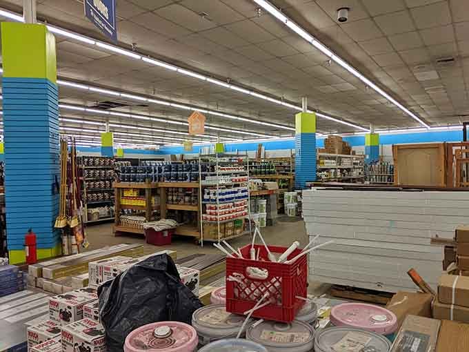 Paint cans and building supplies stretch across warehouse space like a DIY enthusiast's version of Disneyland.