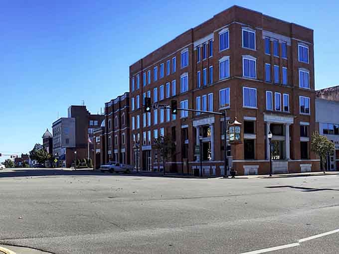 Historic storefronts stand shoulder to shoulder, their varied facades telling stories of commerce that predates online shopping anxiety.