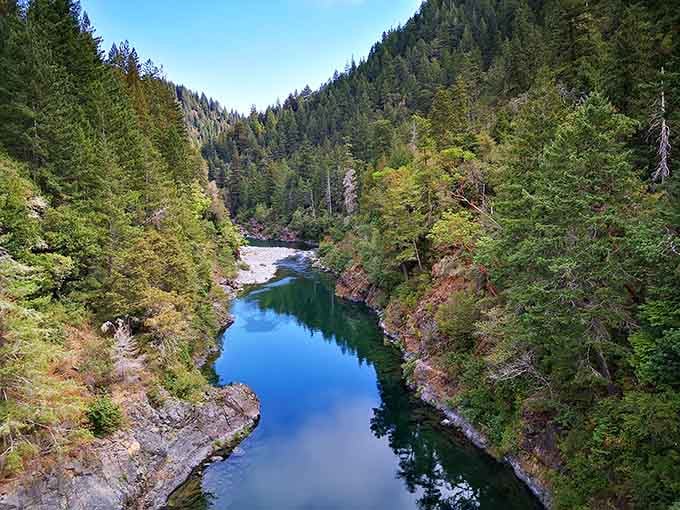 The Smith River carves through ancient redwood groves, its turquoise waters flowing like liquid gemstones between canyon walls.