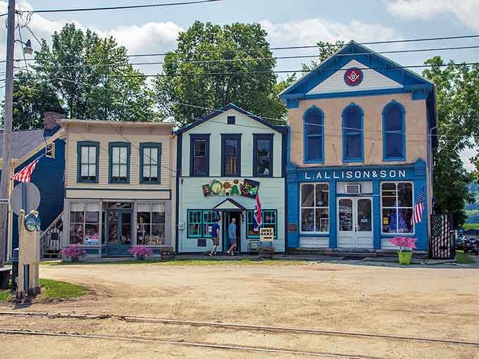 Three colorful buildings stand shoulder to shoulder like a cheerful welcoming committee greeting visitors to this charming historic district.