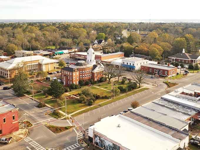 The courthouse dome rises above autumn trees in a bird's-eye view of classic small-town America.