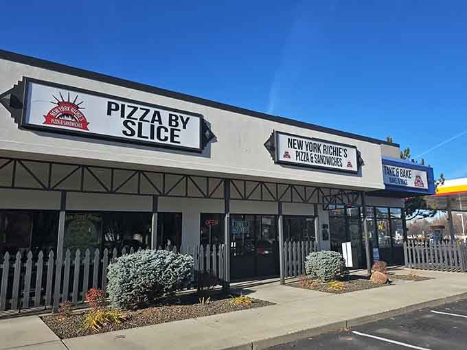 Three different signs promising pizza perfection &ndash; they're not being subtle about their confidence in their slices.