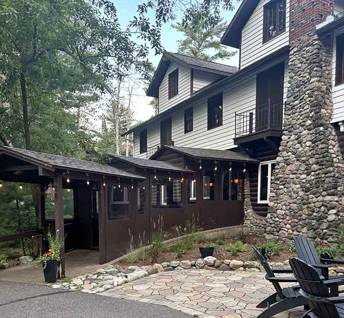 The stone chimney and wooden beams whisper promises of fireside dining and hearty portions after a day on the lake.