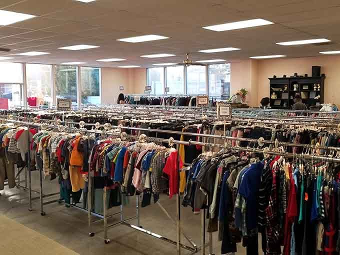 Rows of colorful clothing stretch endlessly under bright lights, organized better than some department stores charge for.
