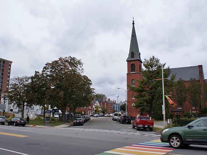 That church steeple rises above the street like a compass needle pointing toward simpler, more affordable times.