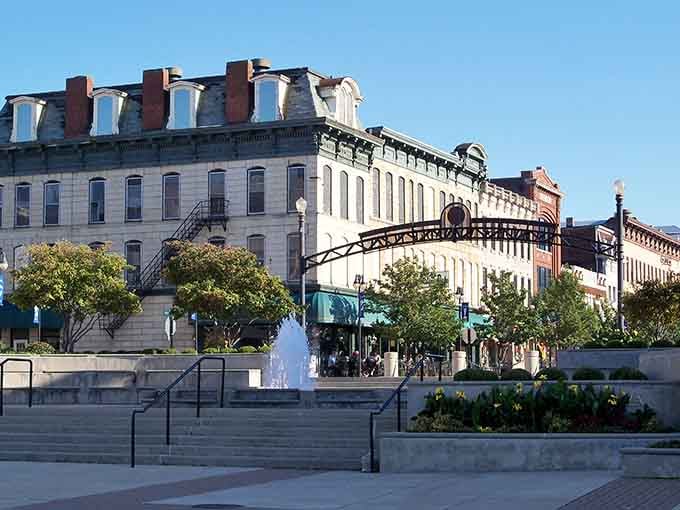 Historic architecture frames a fountain plaza where community gatherings have unfolded for generations under open skies.