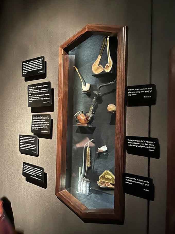 Vintage pipes rest in a shadow box like precious artifacts, each one telling stories only their former owners knew.