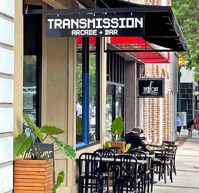 The bold arcade signage above sleek outdoor seating hints at the retro fun waiting inside this urban playground.