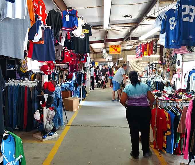 Sports jerseys hang like championship banners while shoppers navigate aisles packed with everything imaginable below.